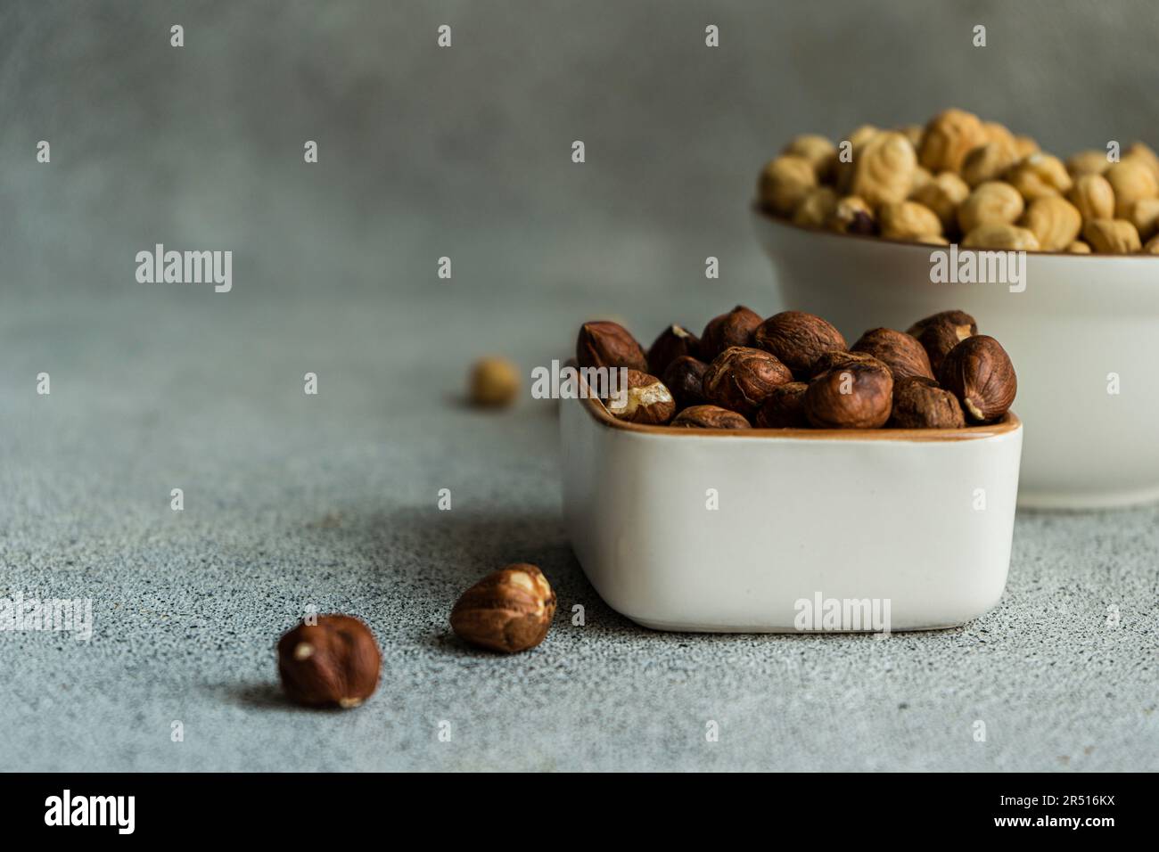 Bowl with organic hazelnuts on a concrete base Stock Photo - Alamy