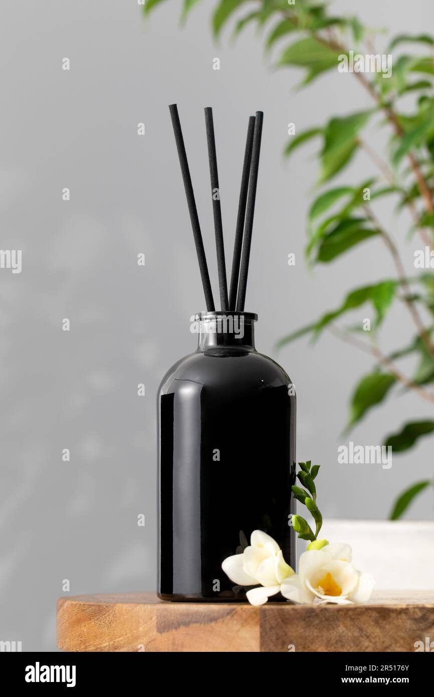 Black glass diffuser with the scent of flowers. The concept of home ...