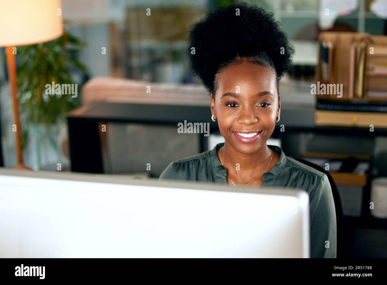 Portrait of black woman at computer with smile in modern office, and ...