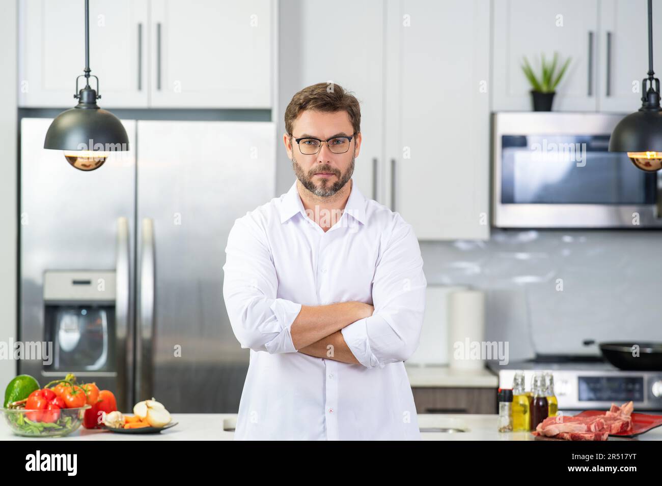 Man cooking food in kitchen. Handsome man cooking healthy food in ...