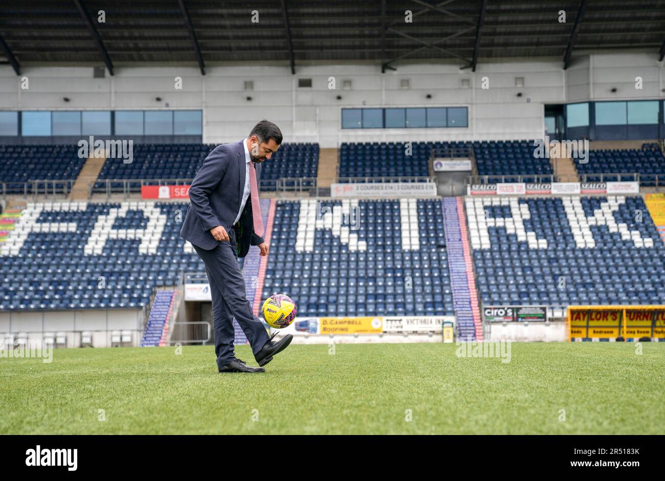 First Minister of Scotland Humza Yousaf kicking a football during a ...