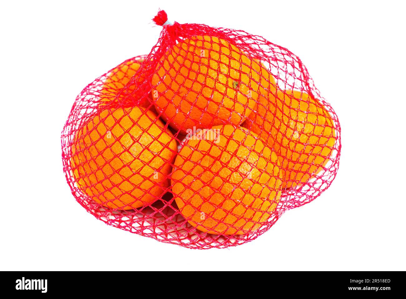 Fresh and juicy oranges in a red mesh bag isolated on white background ...