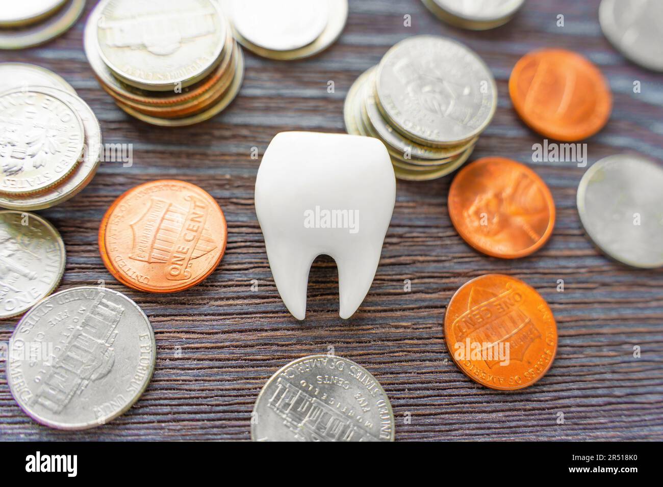 White and clean human tooth model is placed among a pile of scattered ...