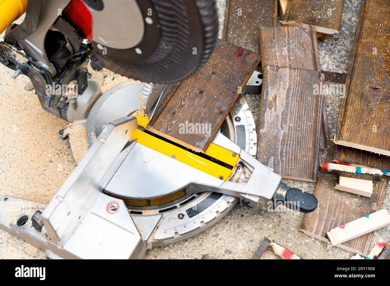 Close-up top-down view of a professional circular saw with a pile of ...