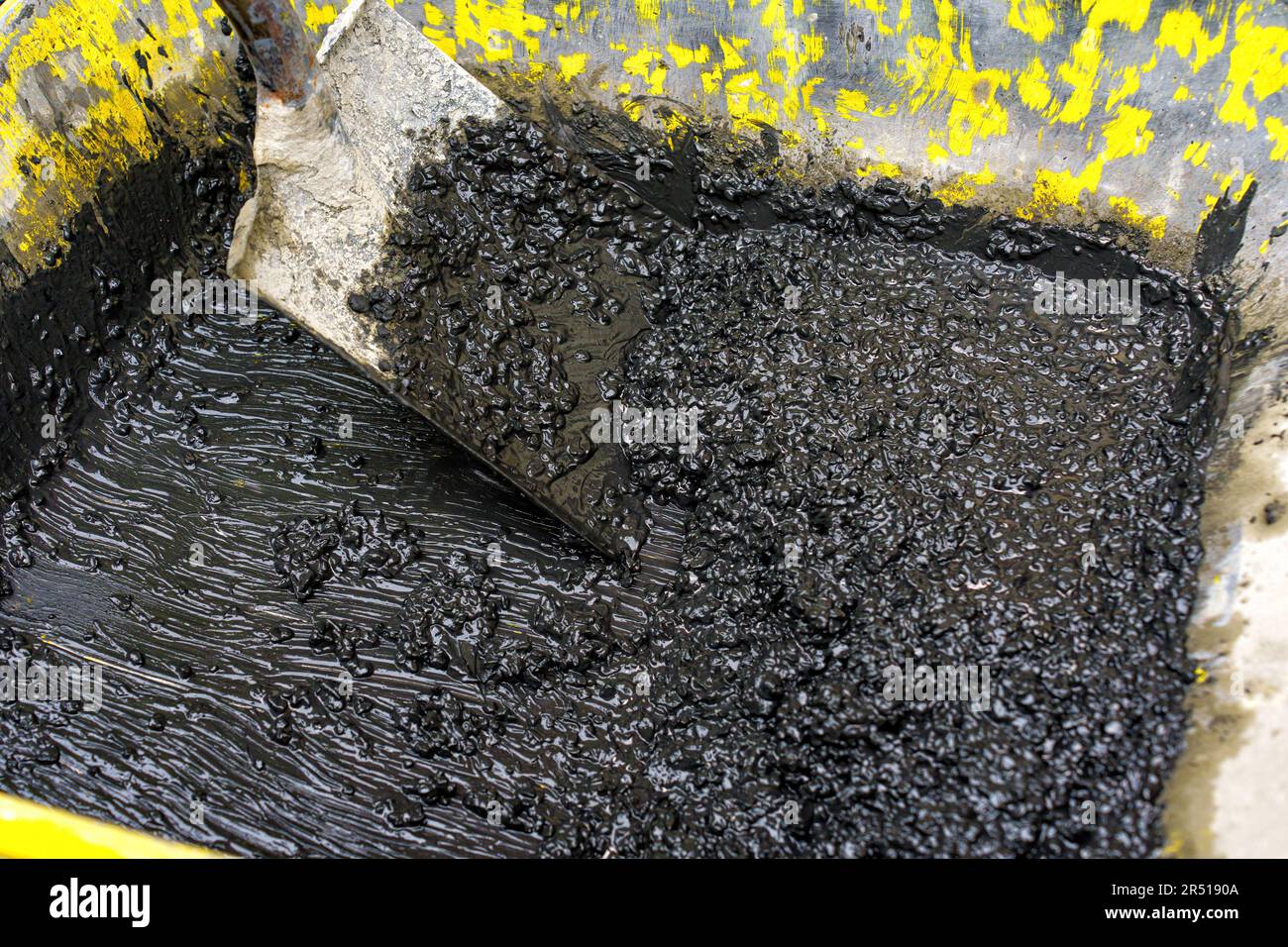 Close-up of shovel scooping terrazzo pavement mixture from a ...