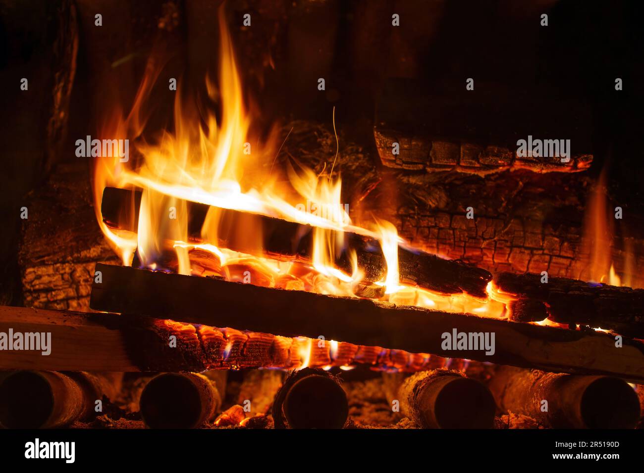 A close-up of a burning fireplace, the heat and flames dancing on the ...