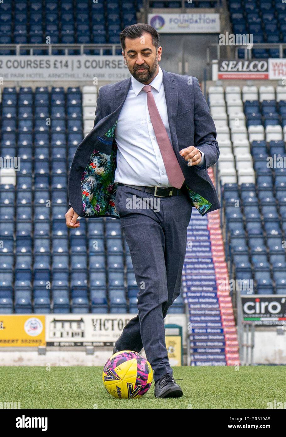 First Minister of Scotland Humza Yousaf kicking a football during a ...