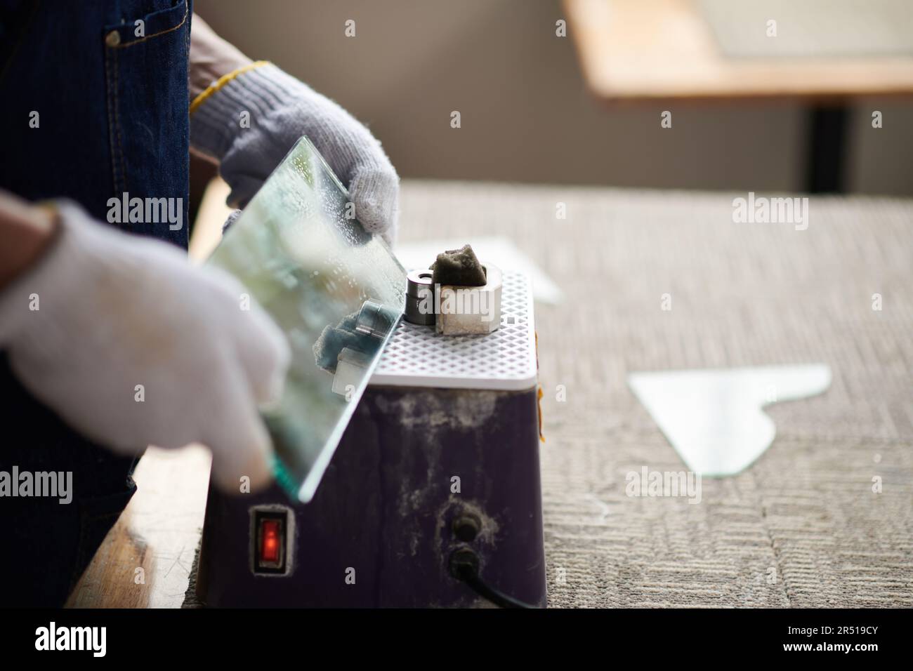 Hands of craftsperson polishing edges of small mirror piece Stock Photo ...