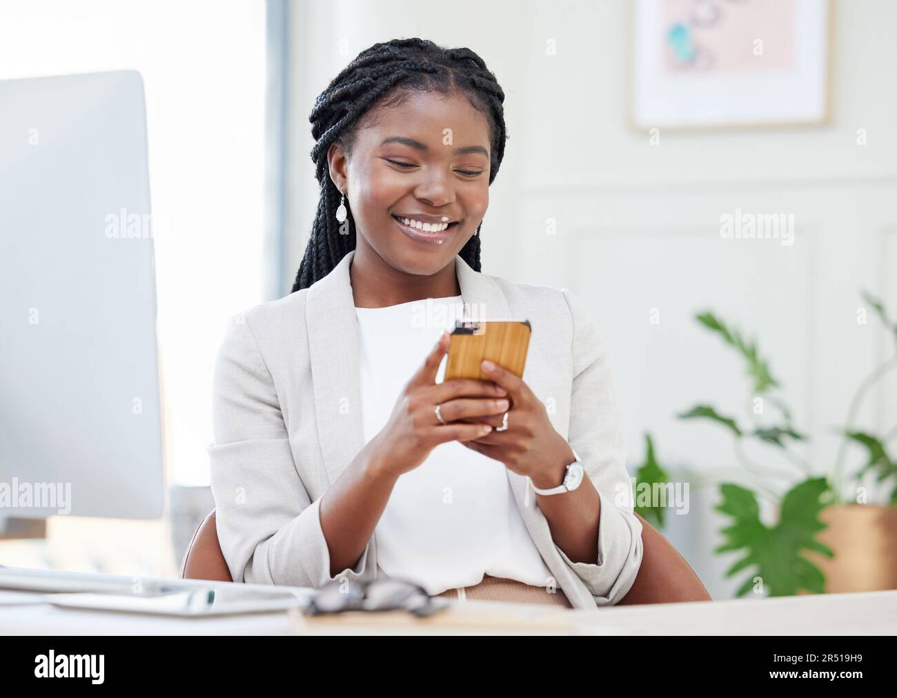 Business, black woman and typing on phone at a desk for communication ...