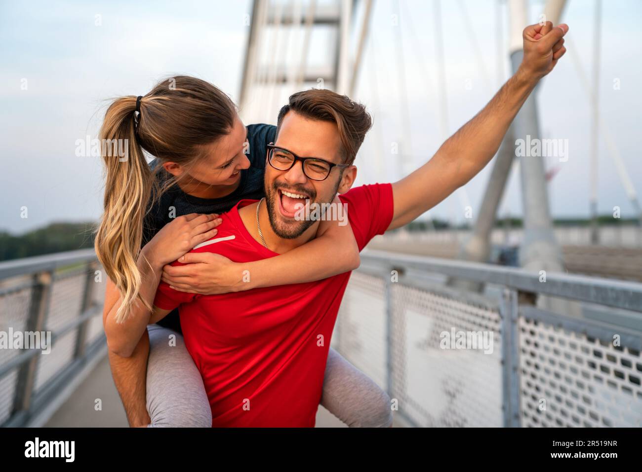 Romantic couple doing sport together on the street. Having fun after ...