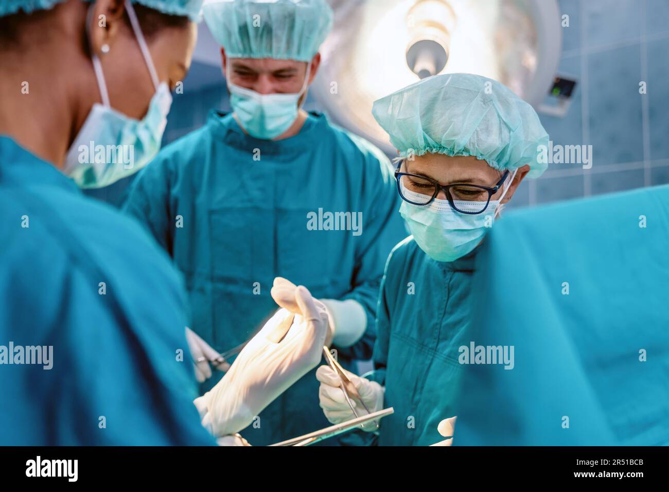 Group of surgeons at operation in operating room at hospital. Surgery ...