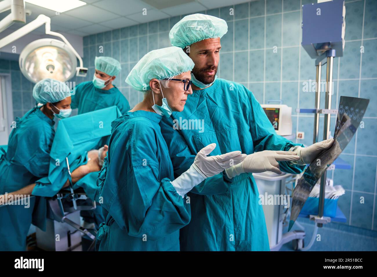Group of surgeons at operation in operating room at hospital. Surgery ...