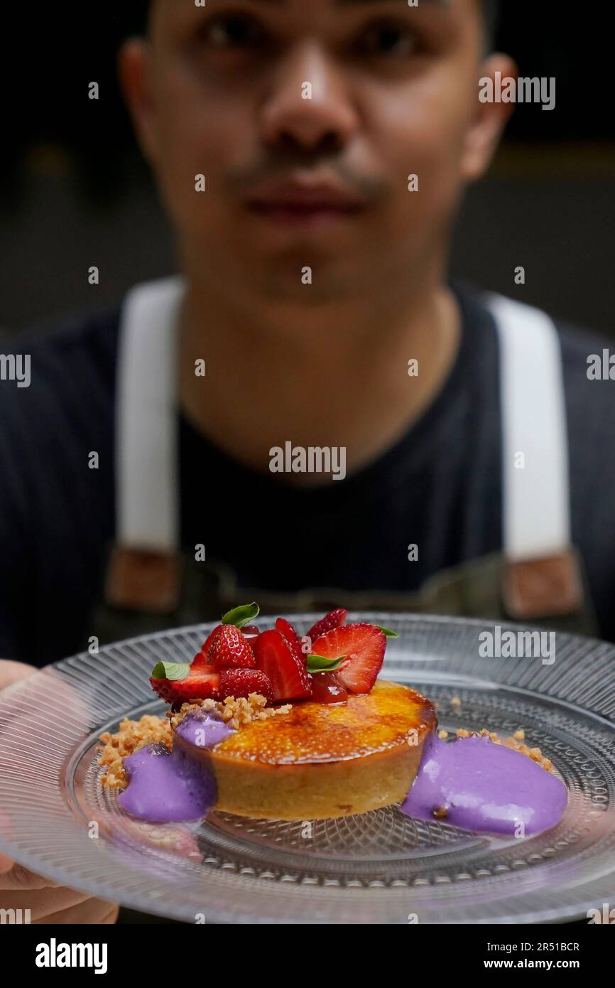 Pastry chef Vince Bugtong holds a Crème Brûlée Tart, made of lemon ...