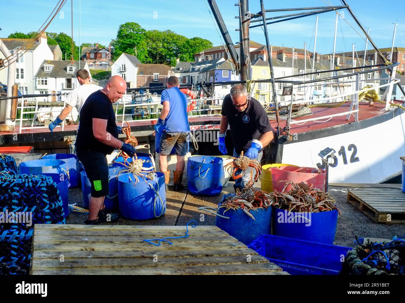 crab fishing and fishermen at weymouth harbour, dorset, england, uk ...