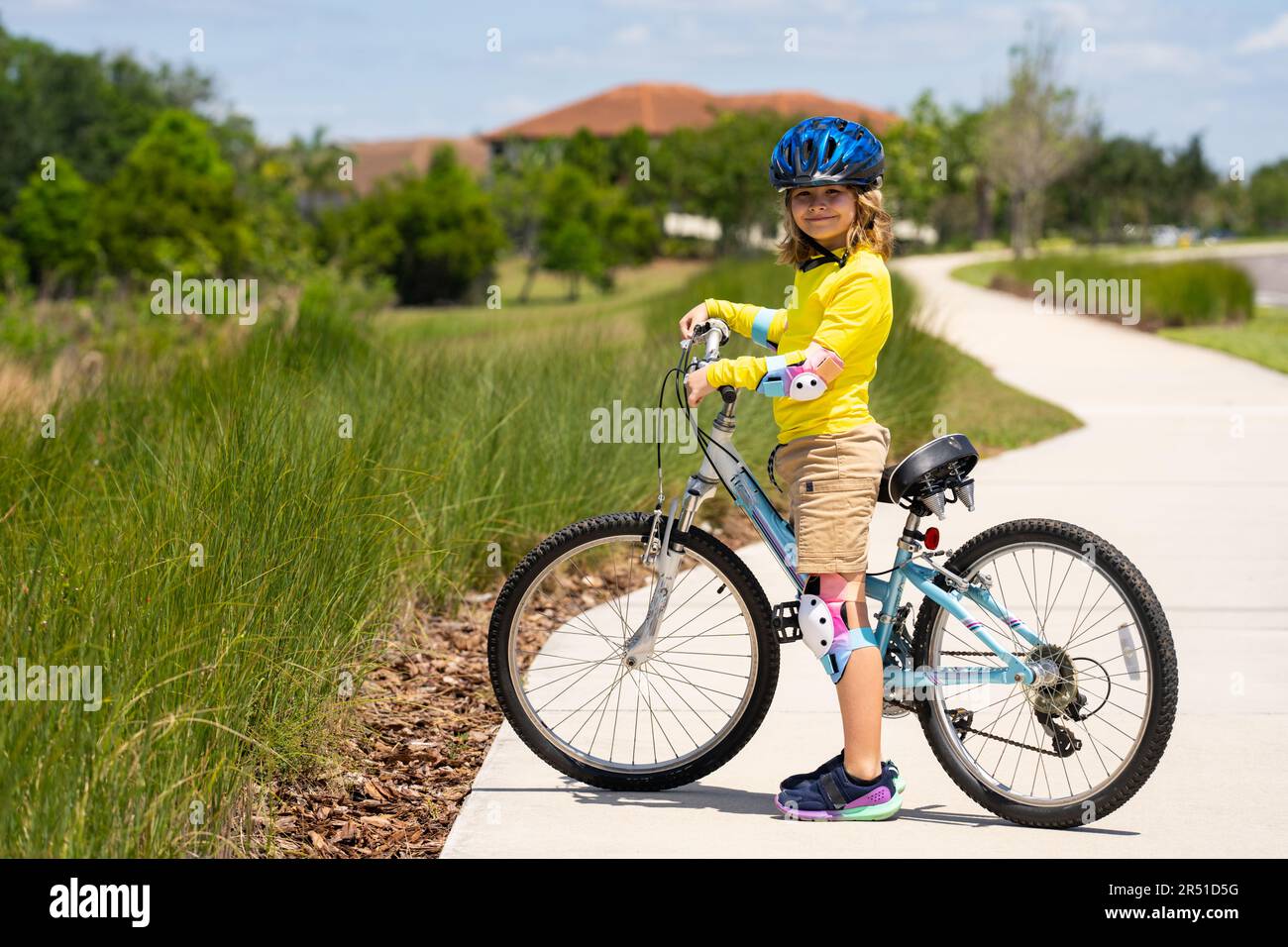 Boy in a helmet riding bike. Boy in safety helmet riding bike in city ...