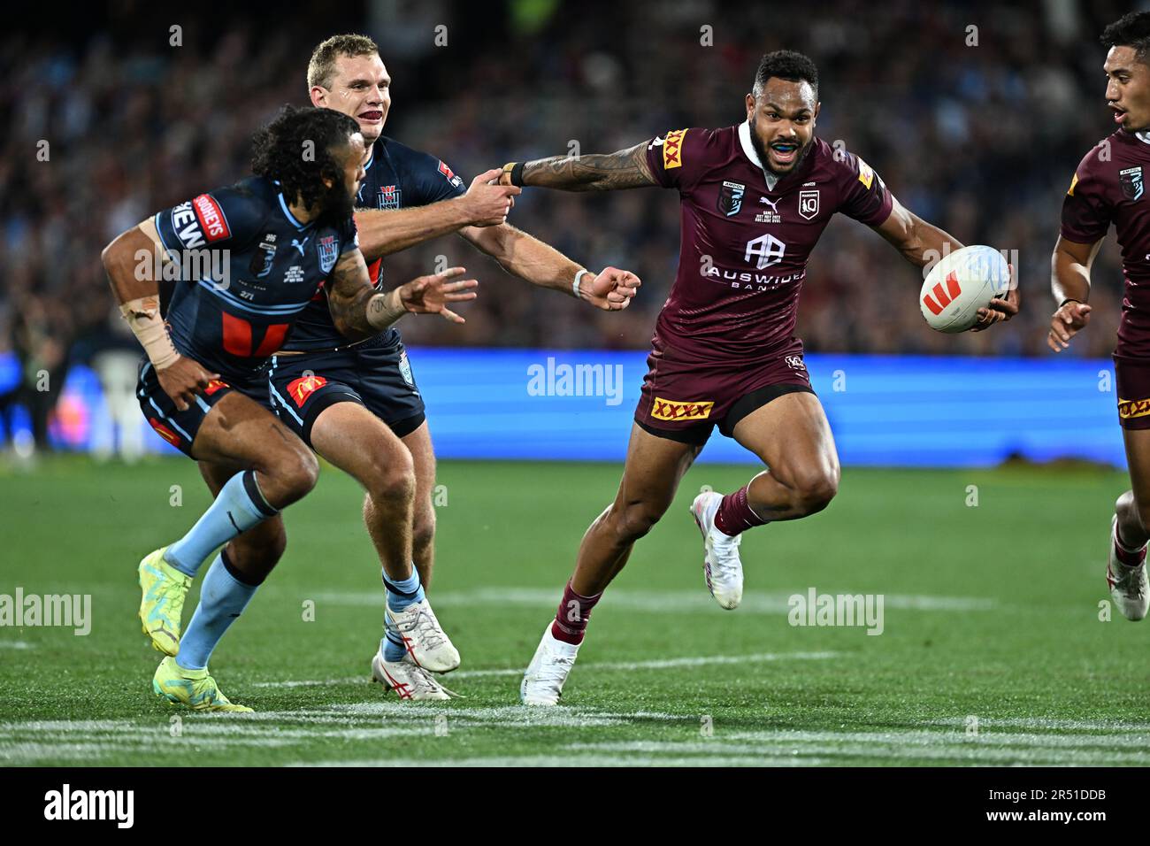 Hamiso Tabuai-Fidow of the Maroons fends off Tom Trbojevic of the Blues ...