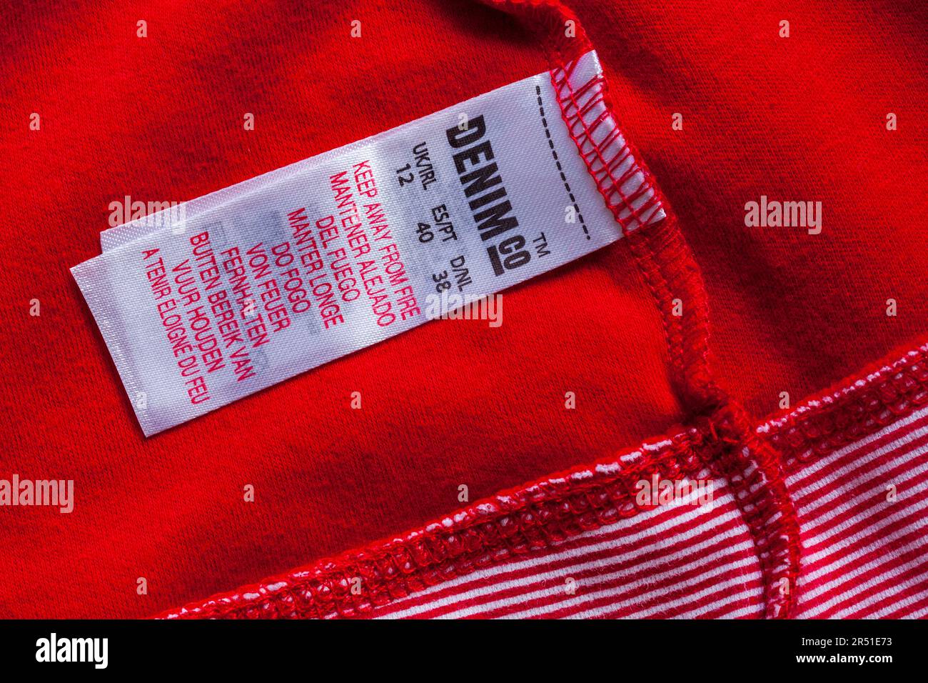 Denim Co label in woman's red hooded garment - Denim Co logo Stock ...
