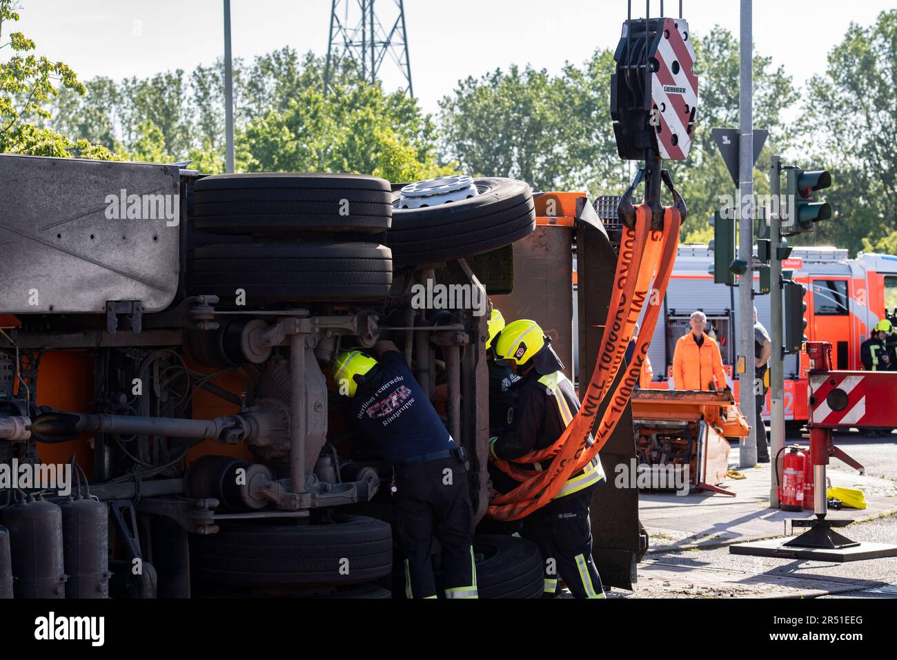 Berlin, Germany. 31st May, 2023. Firefighters stand by an overturned ...