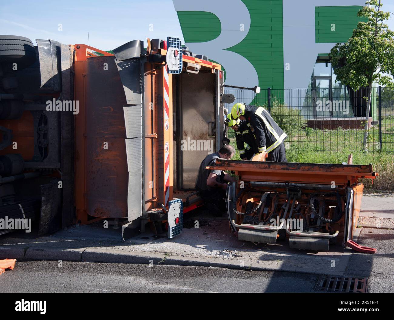 Berlin, Germany. 31st May, 2023. Firefighters stand by an overturned ...