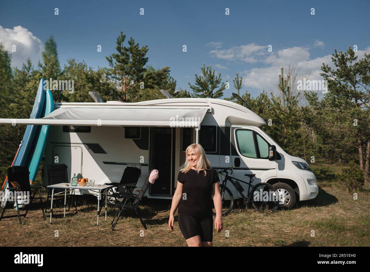 A happy tourist in her motorhome in nature Stock Photo - Alamy