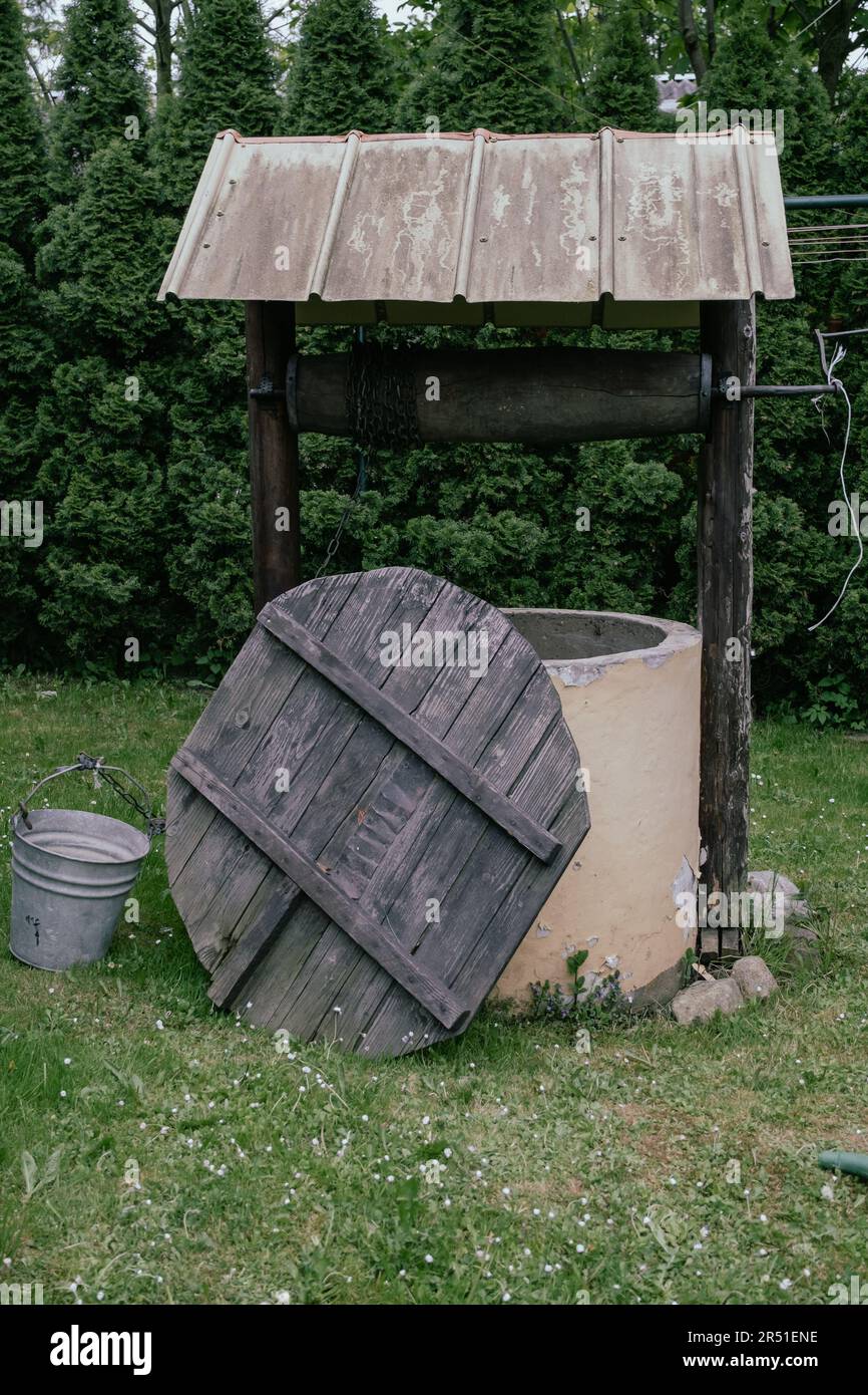 Old well - lid covering the garden well Stock Photo - Alamy