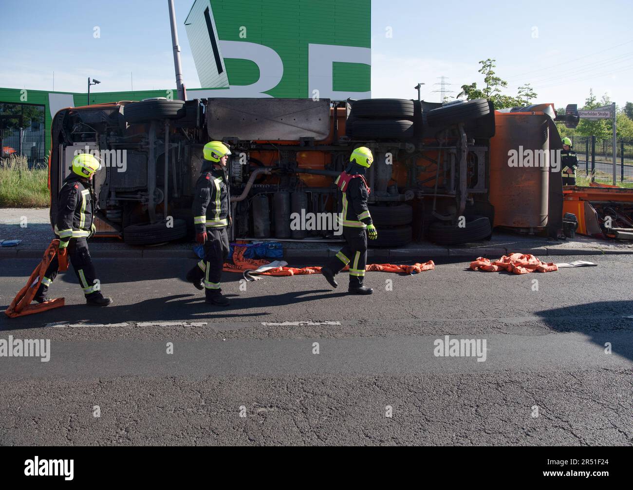 Berlin, Germany. 31st May, 2023. Firefighters walk past an overturned ...