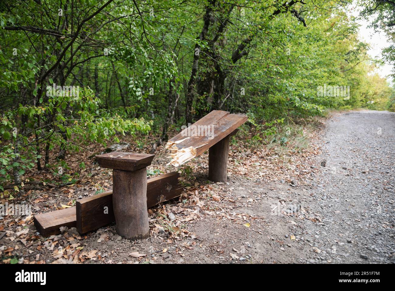 Deliberately damaged wooden bench in a public park - vandalism concept ...