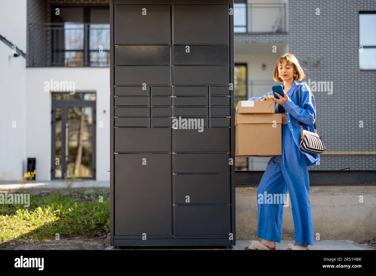 Woman picks up parcels from automatic post office near her home Stock ...