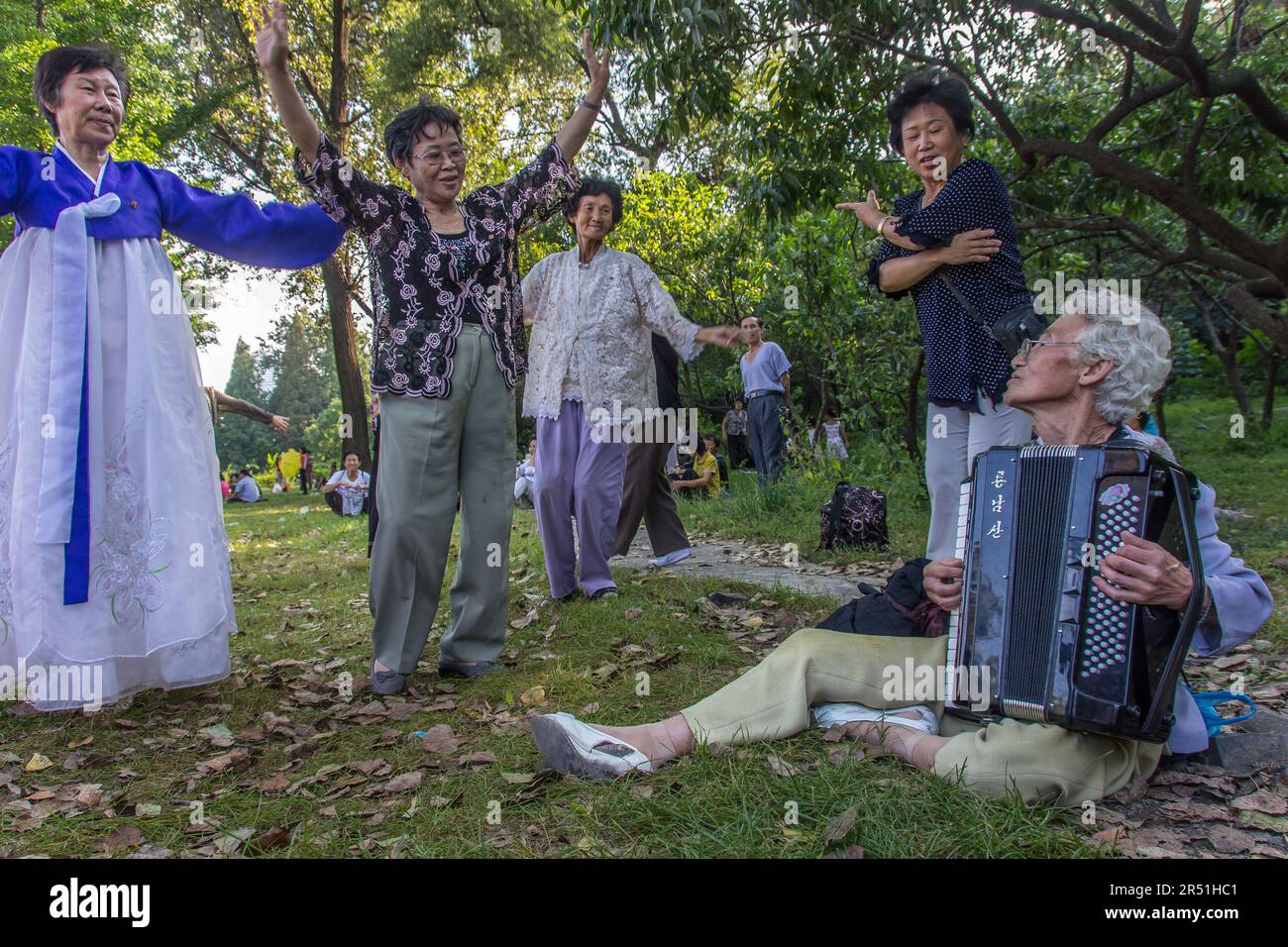 north korean people dancing in a park in Pyongyang during celebration ...