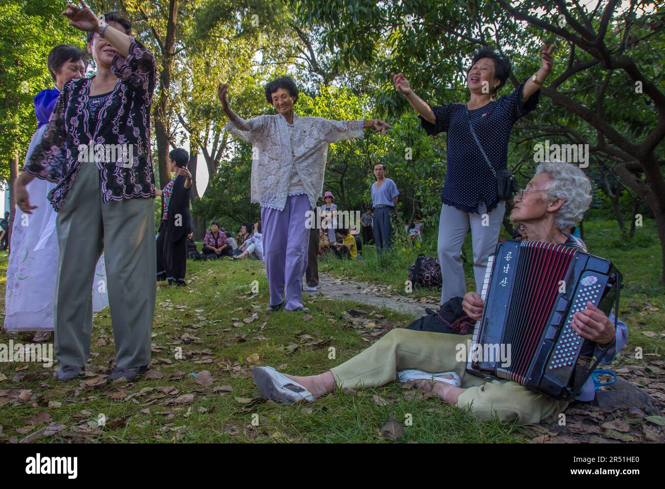 north korean people dancing in a park in Pyongyang during celebration ...