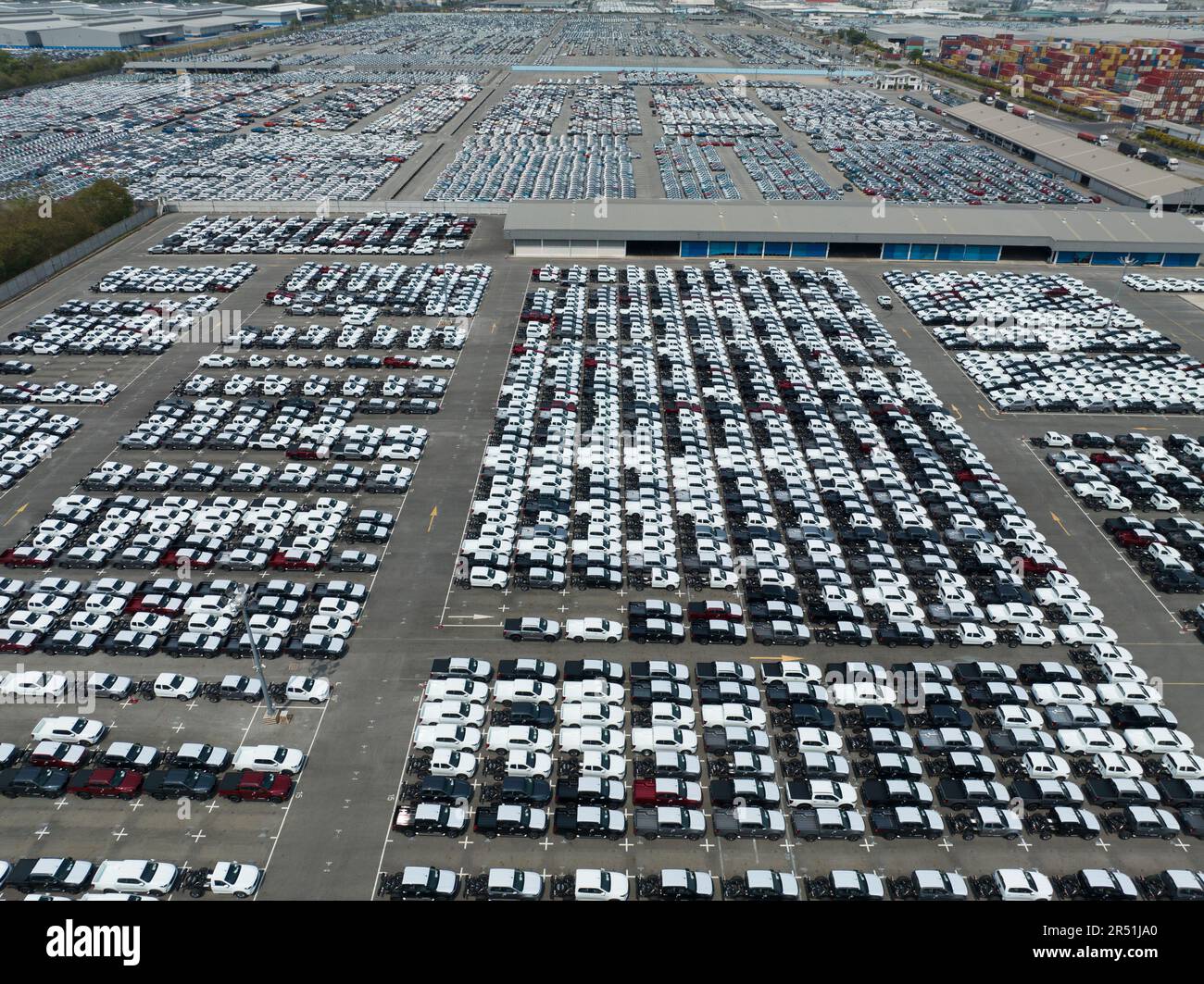 Aerial view of new cars stock at factory parking lot. Above view cars ...