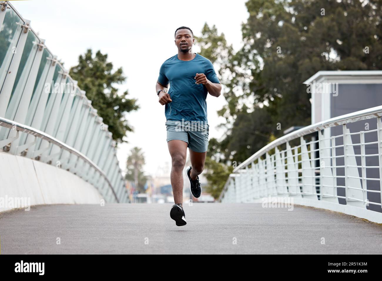 Black man, fitness and running on bridge in city for cardio exercise ...