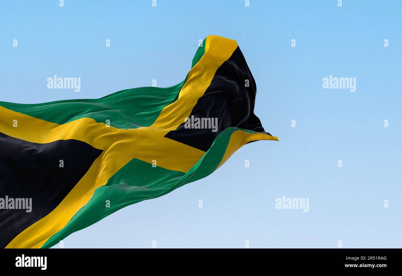 Jamaica national flag waving in the wind on a clear day. Gold saltire ...