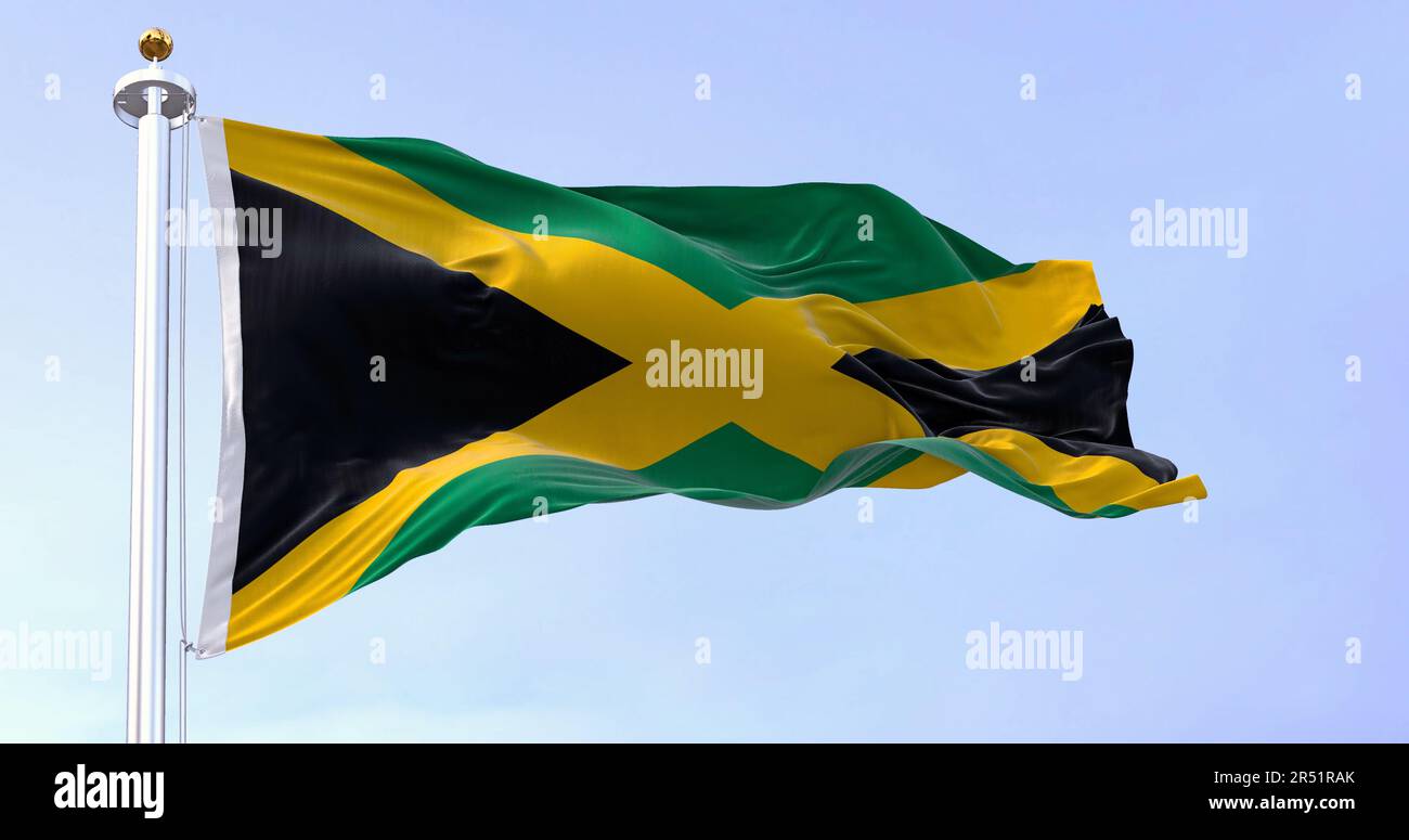 Jamaica national flag waving in the wind on a clear day. Gold saltire ...