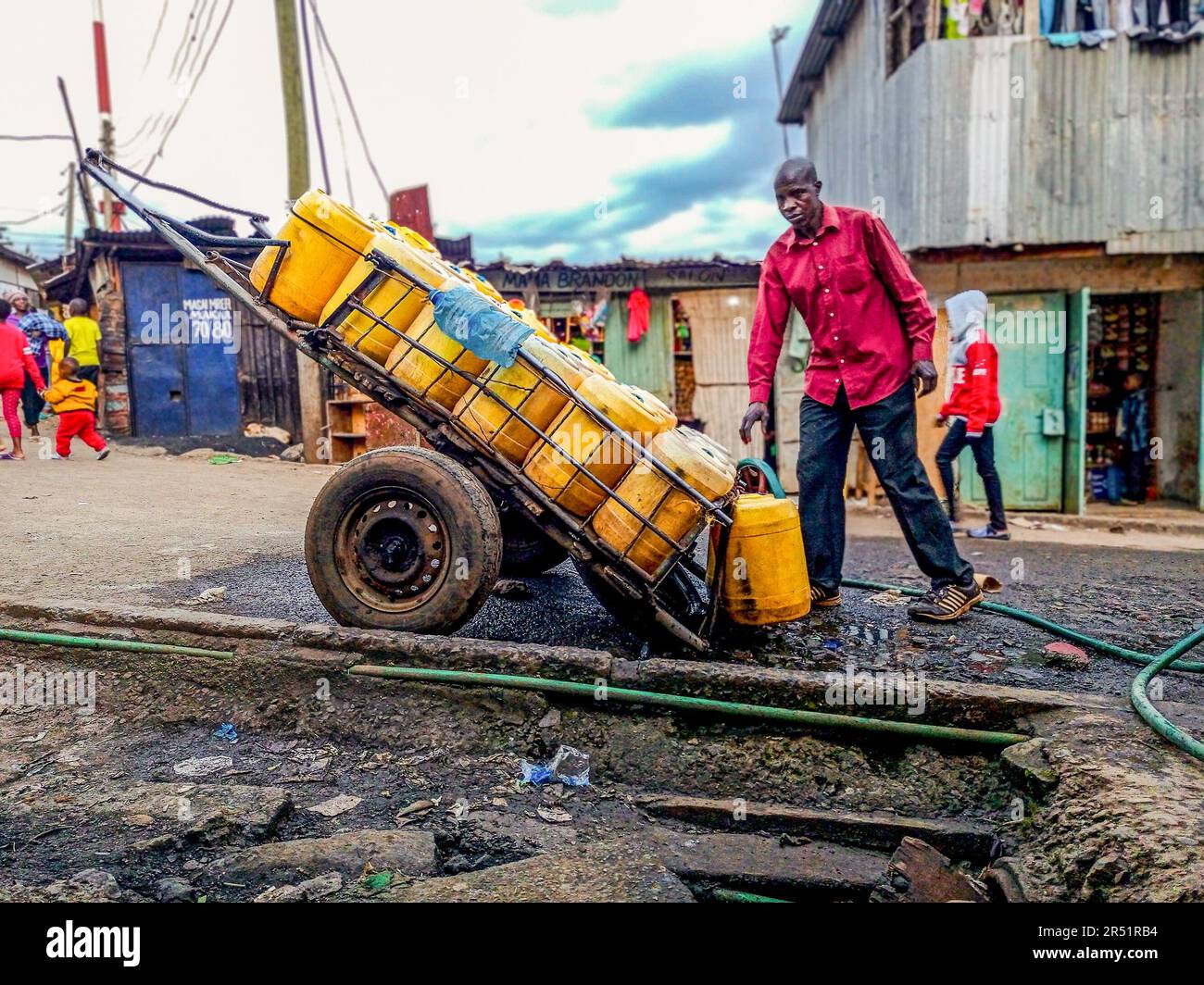 Nairobi, Kenya. 21st May, 2023. A water vendor is refilling his water ...