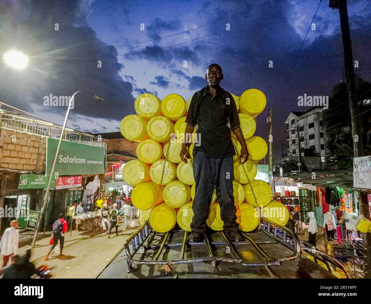 Nairobi, Kenya. 21st May, 2023. A waste collector postures on top of a ...