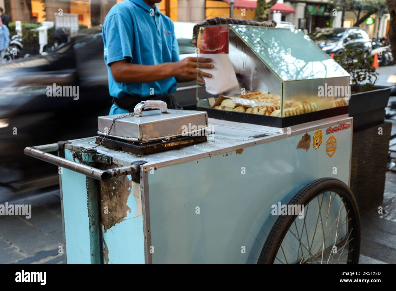 A Street Food Vendor Selling Traditional Bakery in the Street of ...