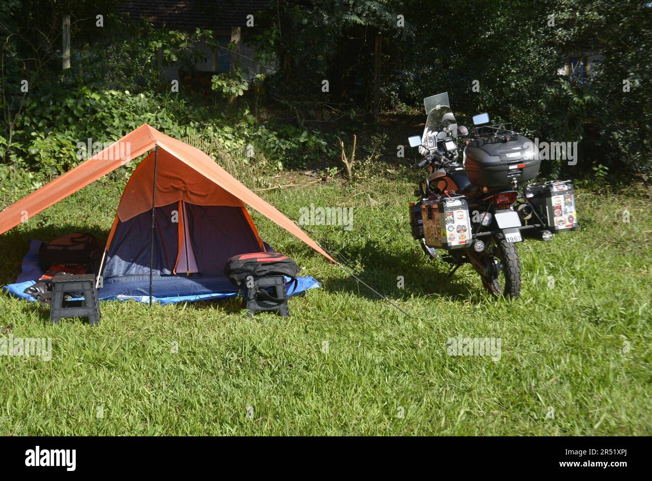 Tent in a camping area with travel motorcycle with various emblems and ...