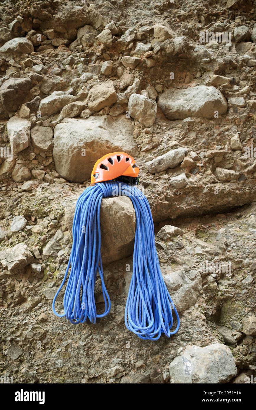 Blue climbing rope and helmet leaning against a rock face in Mallos de ...