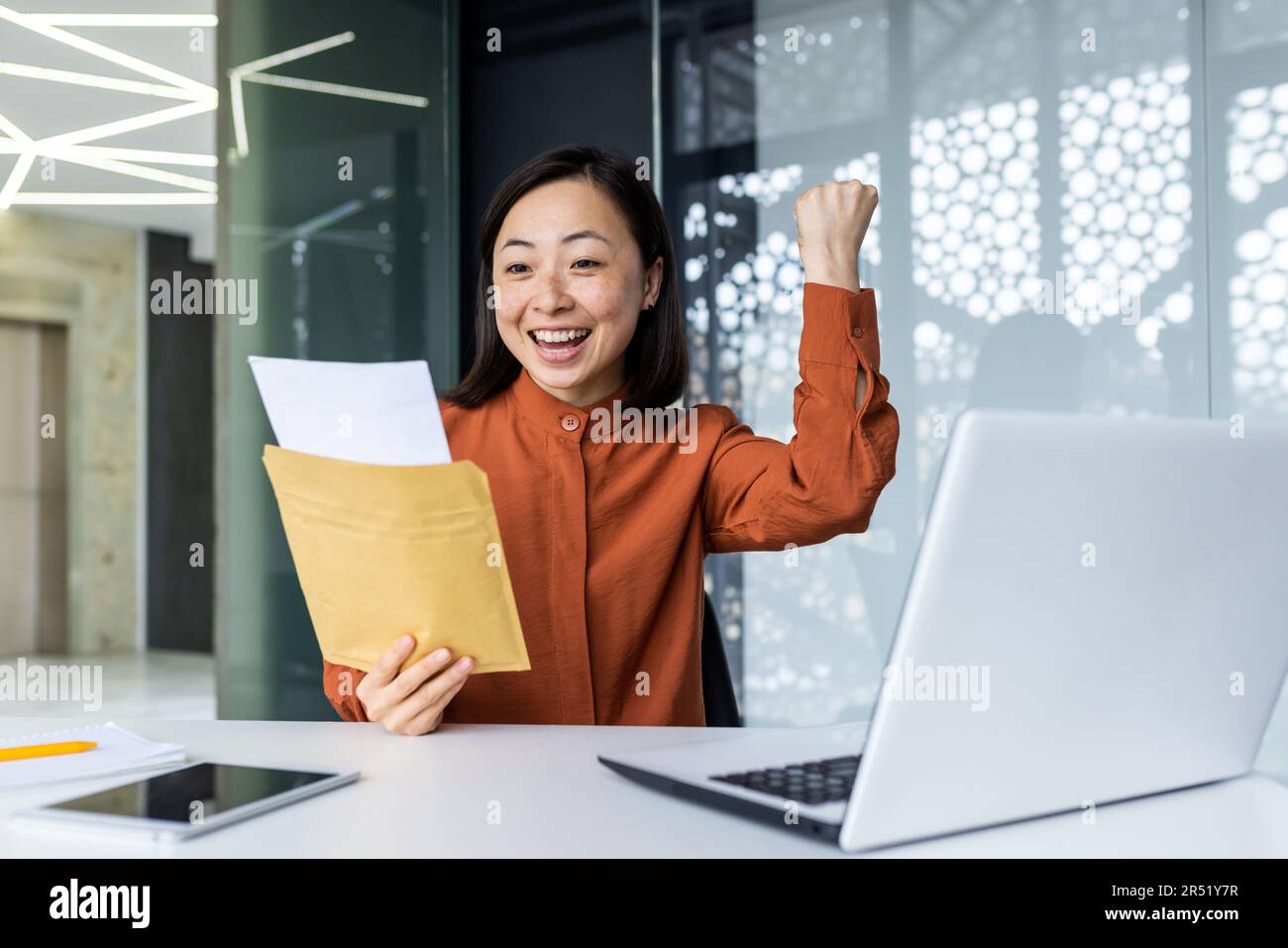 Happy Asian business woman received letter from bank notification in ...