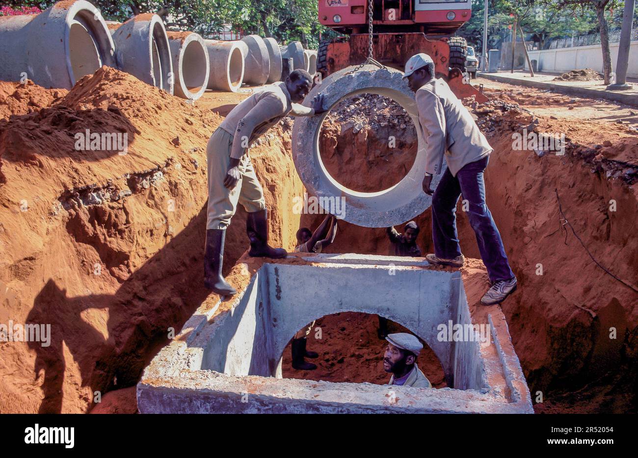 Mozambique, Maputo; Men working on the (re)construction of the sewer ...