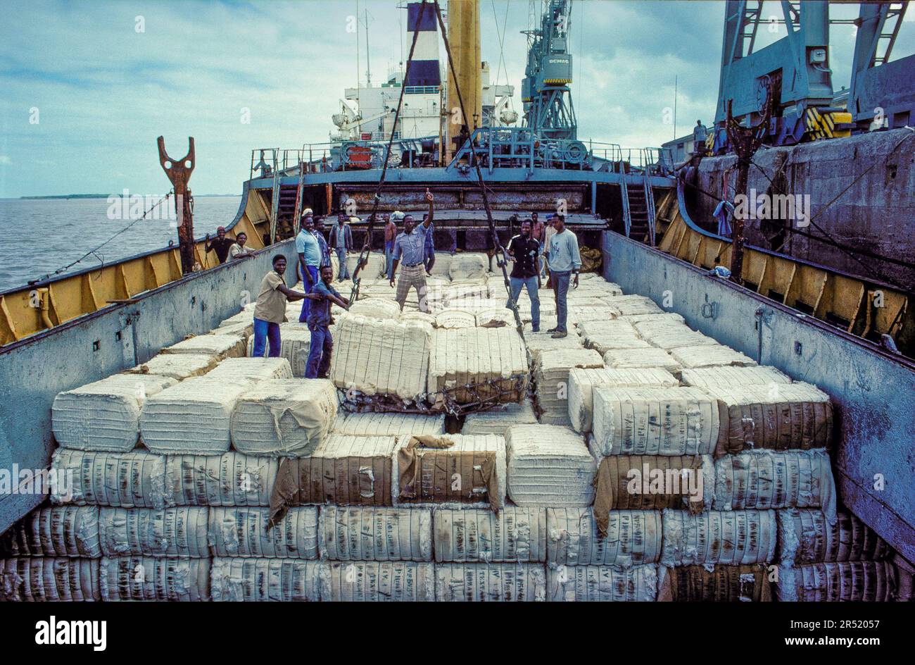 Mozambique, Beira; Bales of cotton are loaded onto a ship in the port ...
