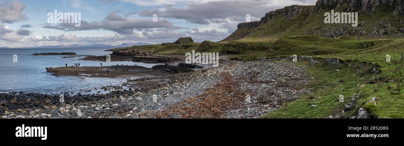 Panorama view of rocky coast, beach and grass foreshore with groups of ...
