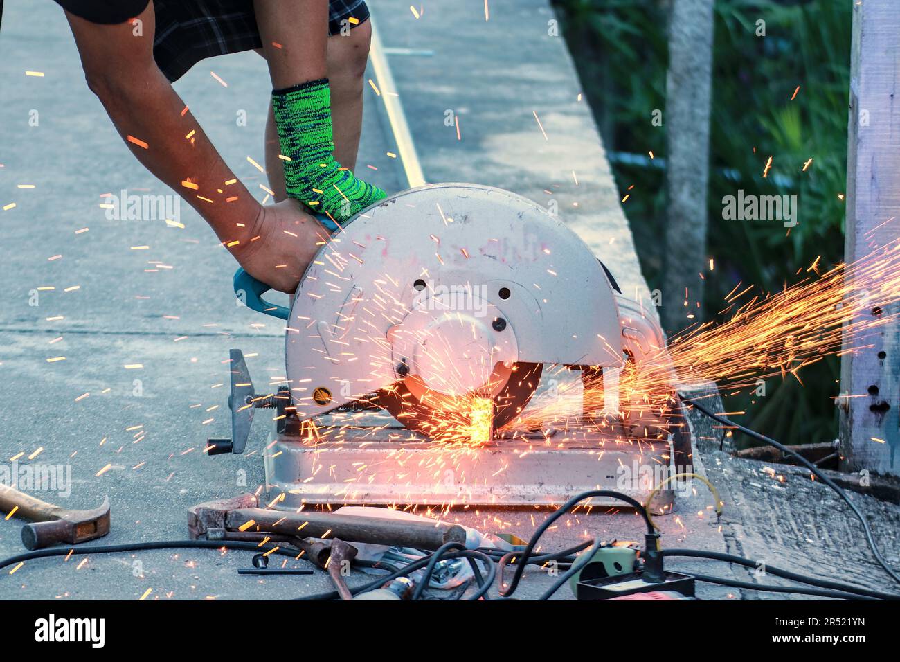 Workers use steel cutters, creating a large number of sparks. Indicates ...