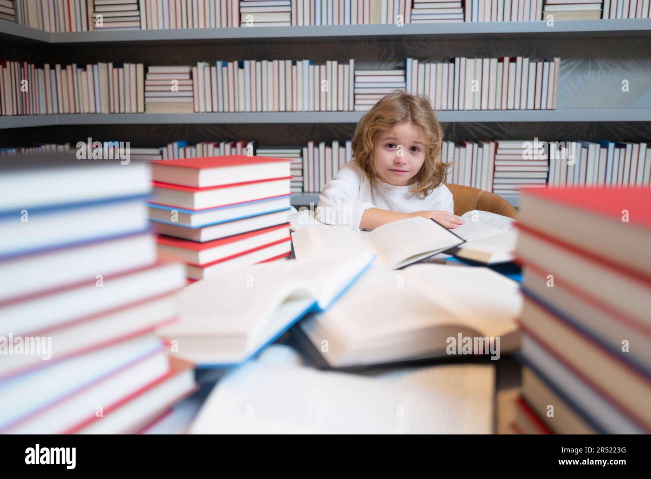 Back to school. School kid with pile of books. Children enjoying book ...