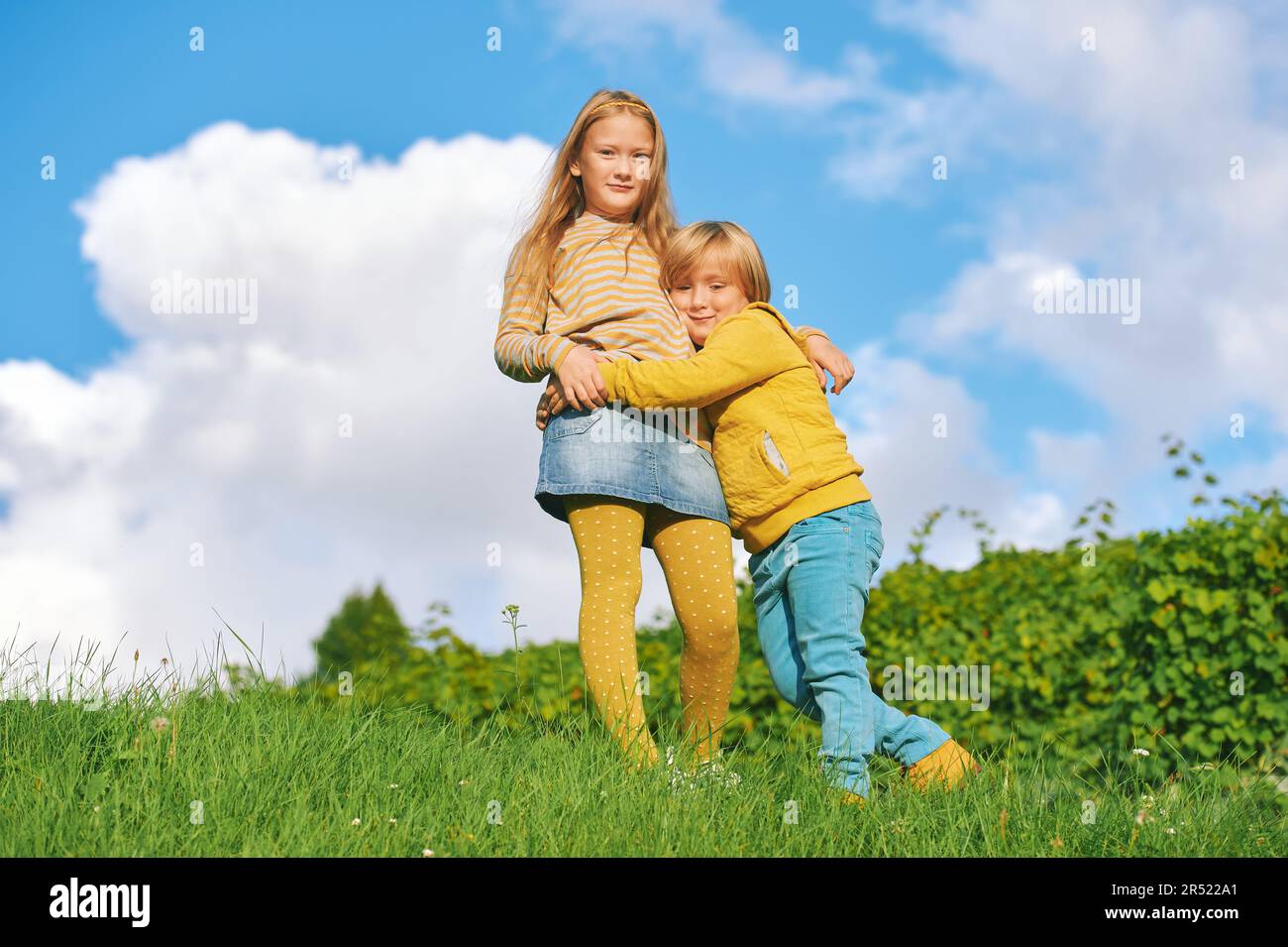 Portrait of 2 funny children playing together outside Stock Photo - Alamy