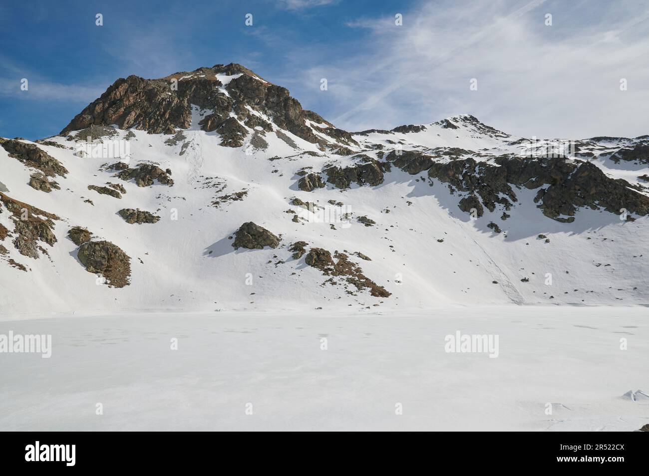 Amazing landscape of massive snowy mountains with high peaks under blue ...