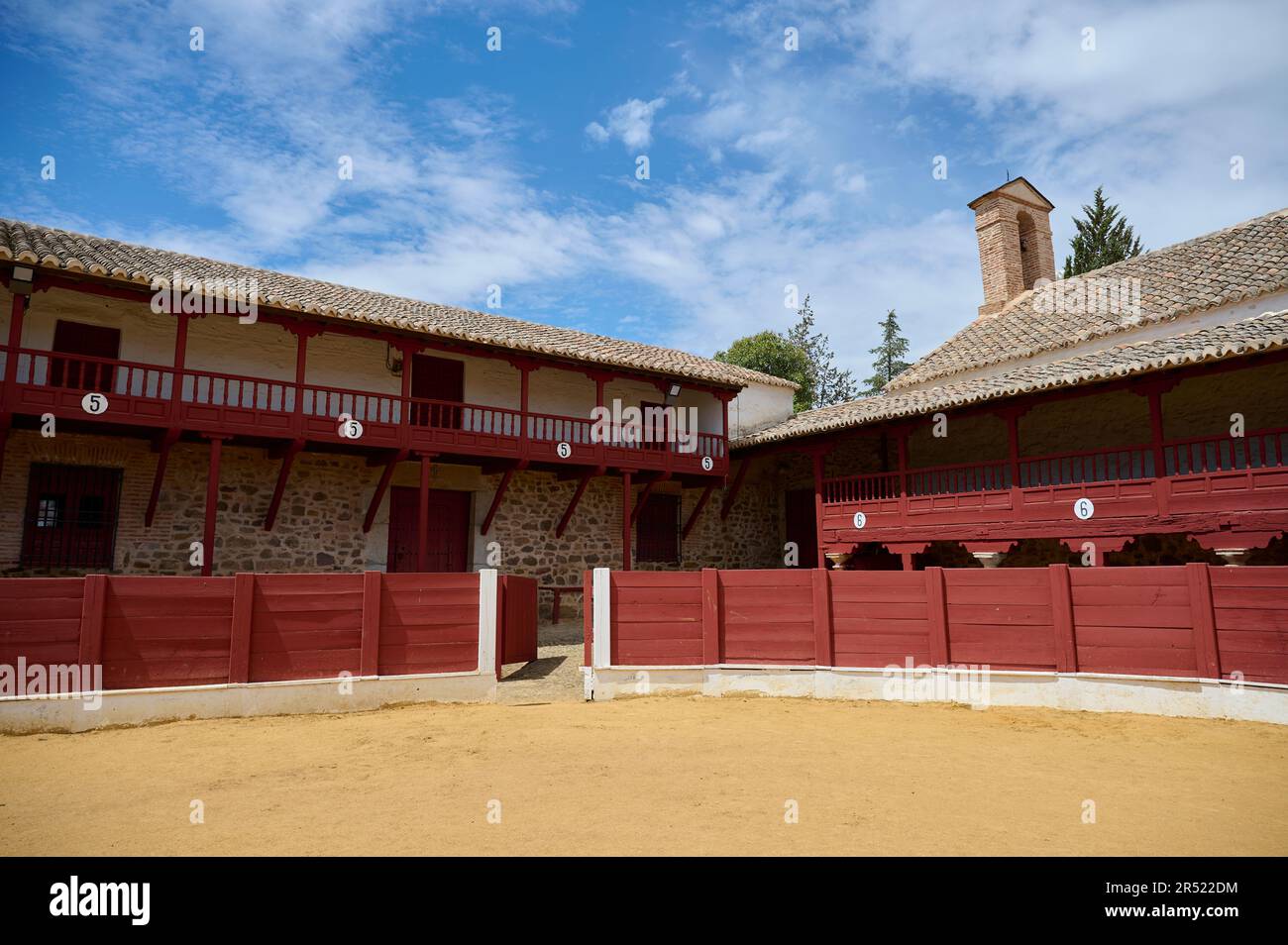 Ancient bullring enclosed with barricades of red walls and spectator ...