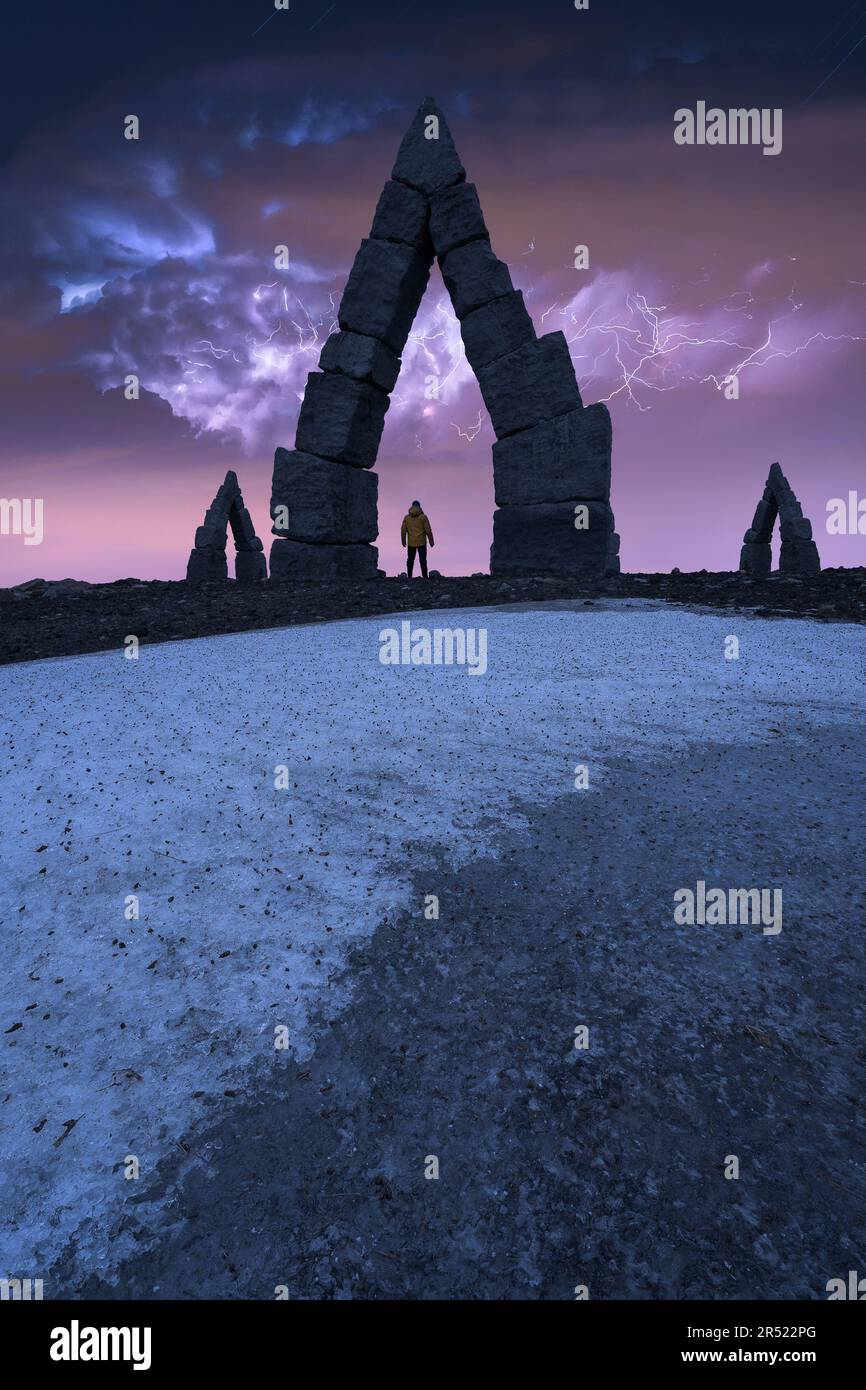 Silhouette of unrecognizable traveler standing on the hill below the ...