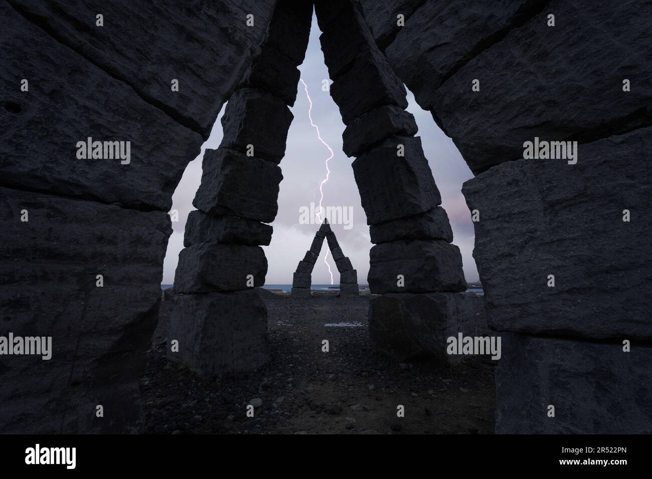Silhouette of Henge circle of aged stone columns and arched passage on ...